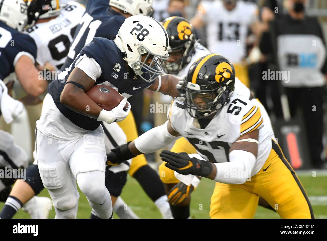 Iowa defensive lineman Chauncey Golston (57) tackles Penn State running ...