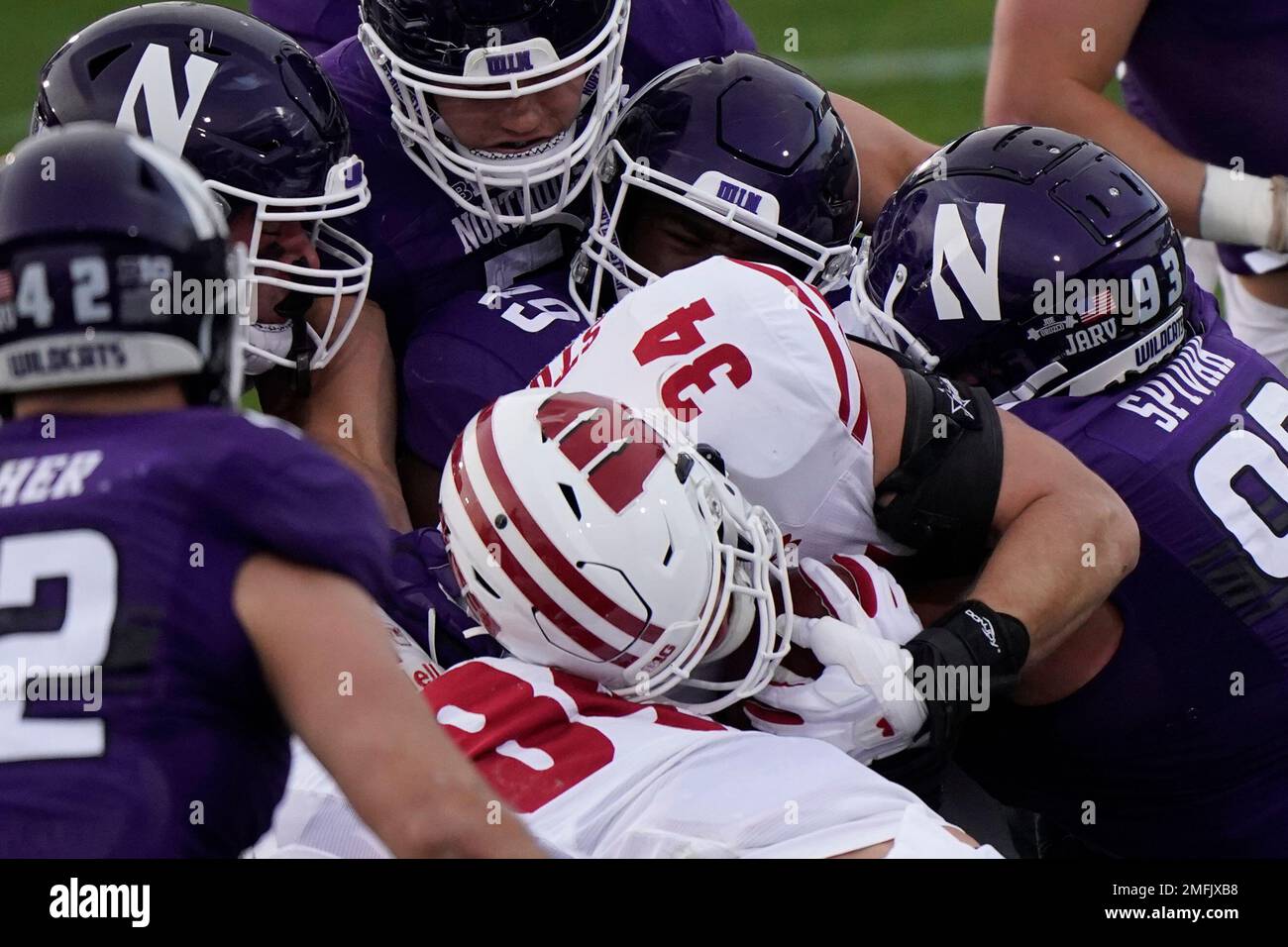 Wisconsin fullback Mason Stokke (34) is tackled by a host of ...