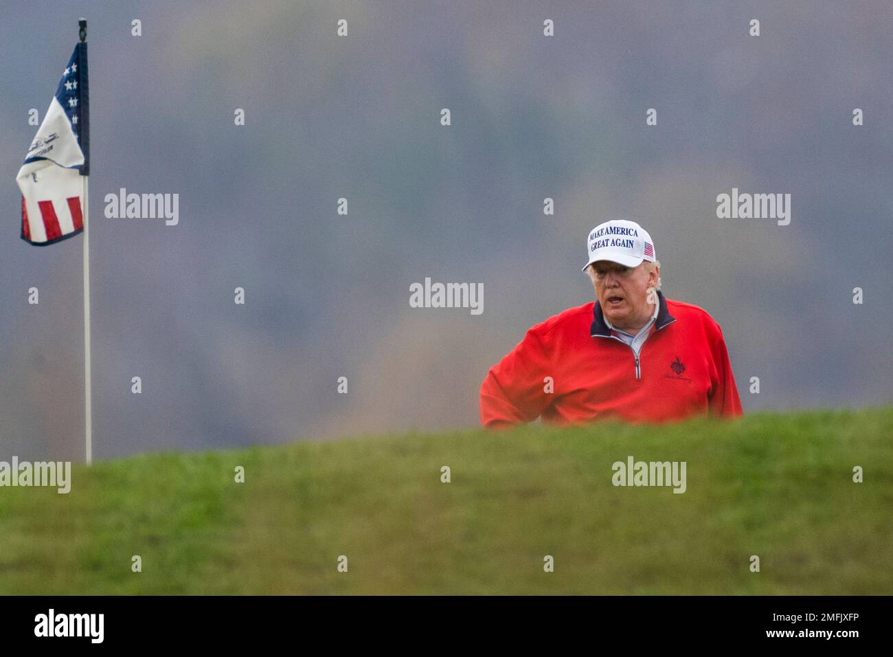 President Donald Trump, left, plays golf at the Trump National Golf ...