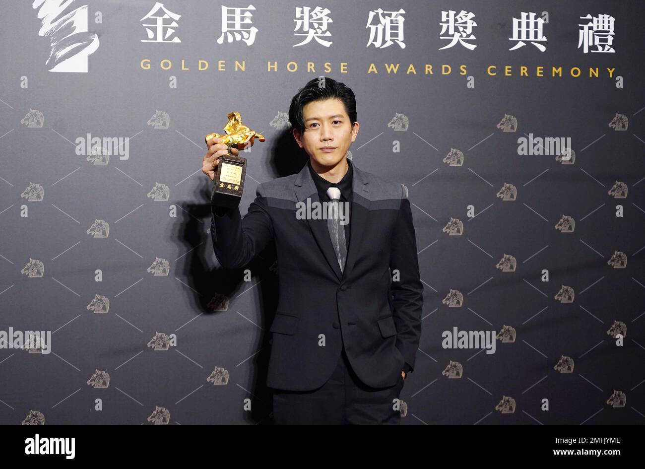 Taiwanese actor Mo Tzu-yi holds his award for Best Leading Actor at the ...