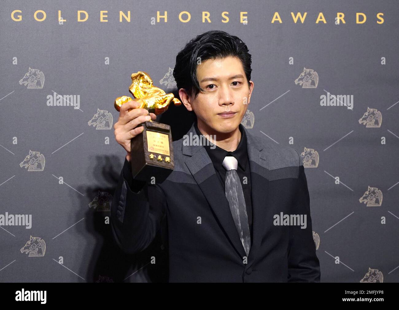 Taiwanese actor Mo Tzu-yi holds his award for Best Leading Actor at the ...