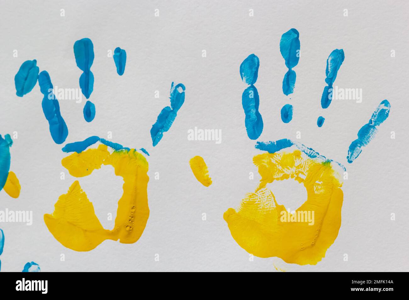 bright prints of children's hands from paint on the wall, background ...