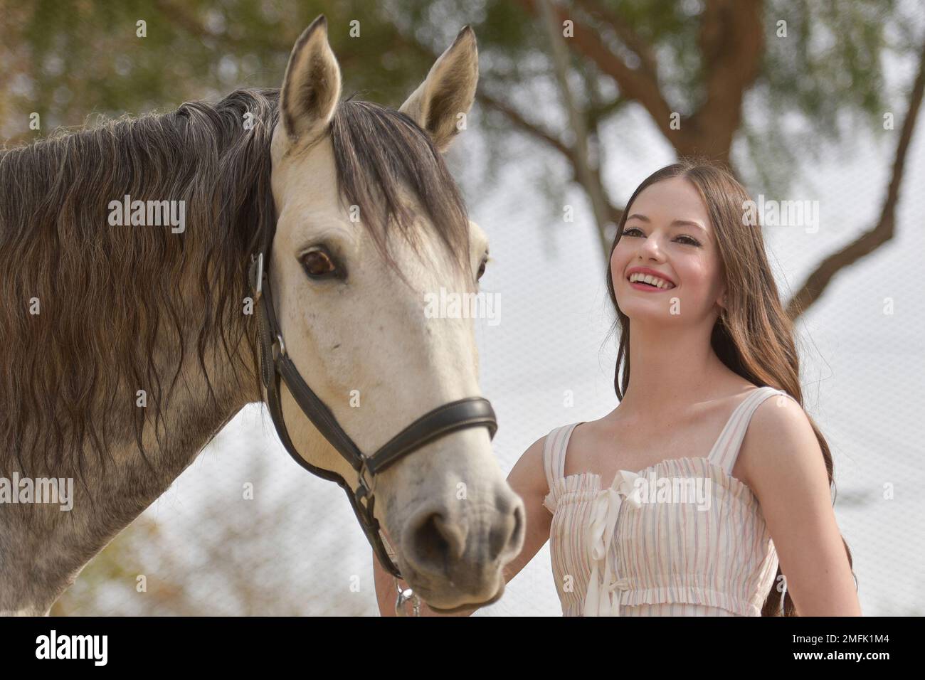 Mackenzie Foy poses with Director Ashley Avis's horse Ghost at an event ...