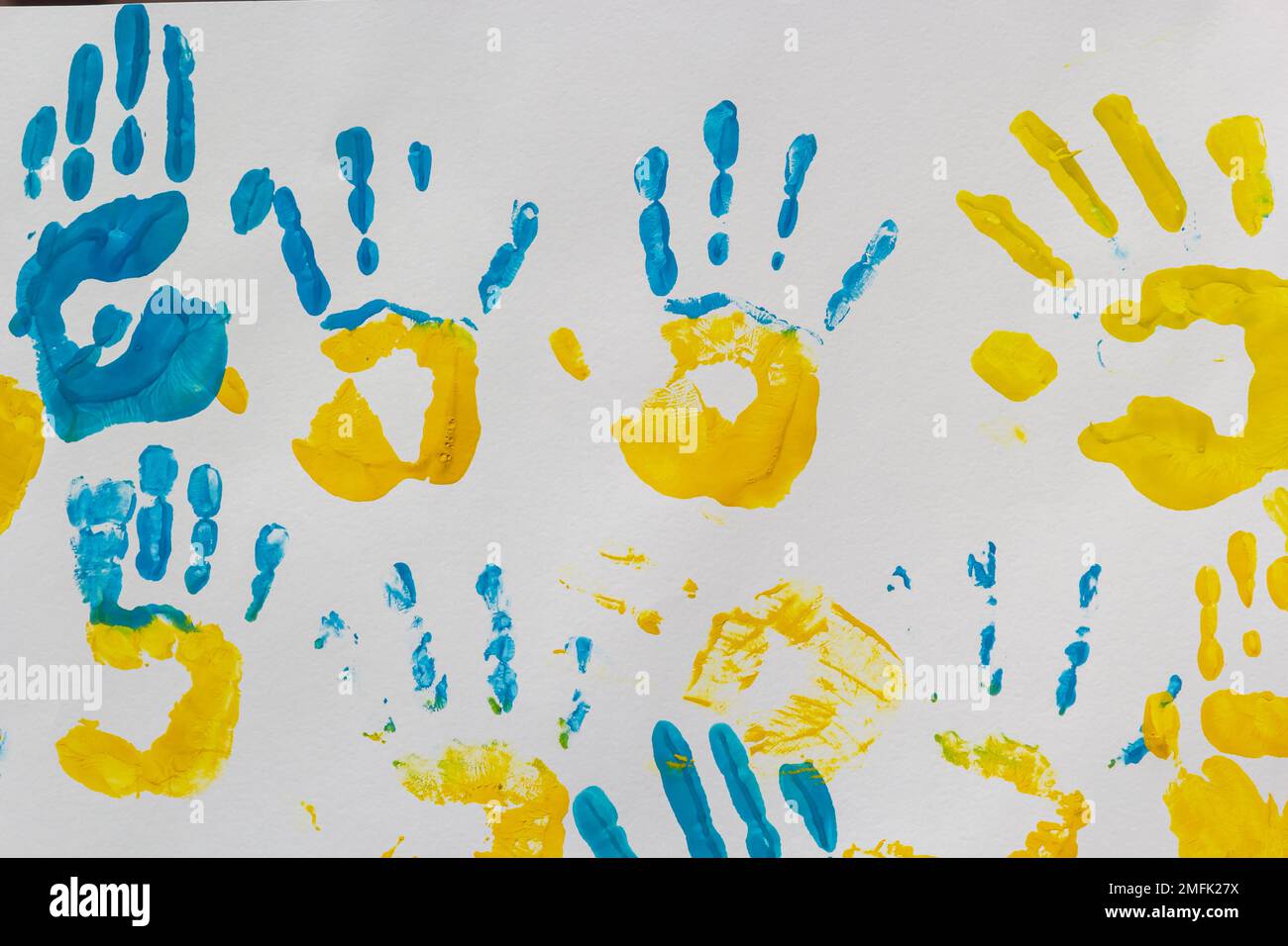 bright prints of children's hands from paint on the wall, background ...