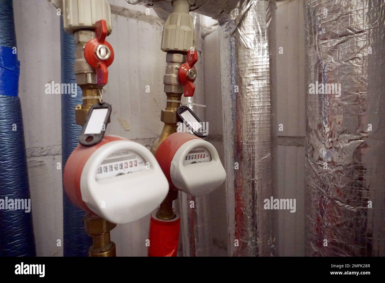 Hot and cold water flow meters installed on pipes Stock Photo - Alamy