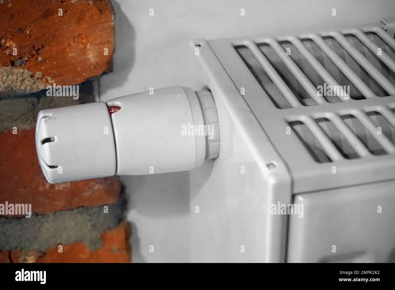 Central heating radiator with a regulator Stock Photo - Alamy