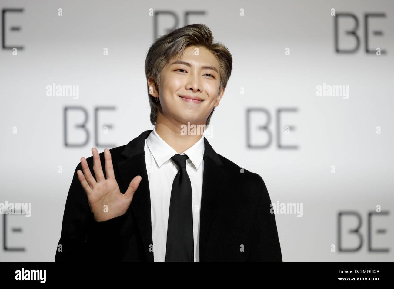 RM, a member of South Korean K-pop band BTS, poses for photographers ...