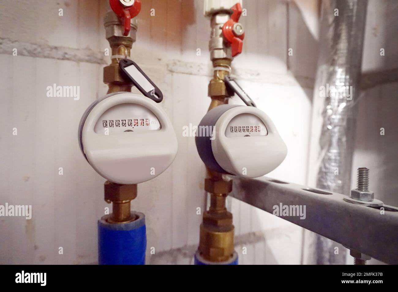 Hot and cold water flow meters installed on pipes Stock Photo - Alamy