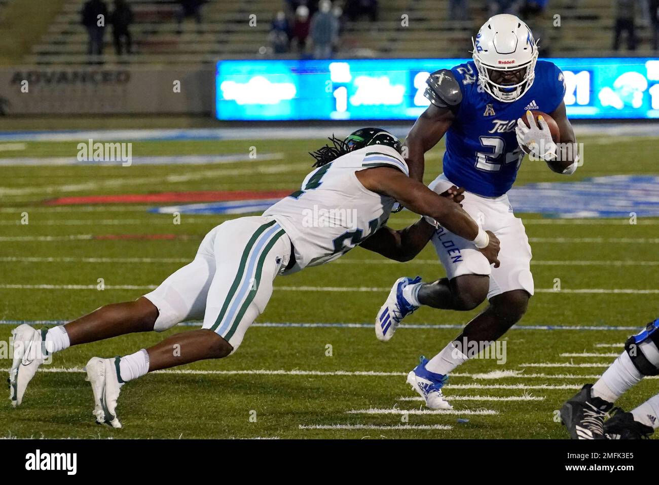 Tulsa running back Corey Taylor II, right, avoids a tackle by Tulane ...