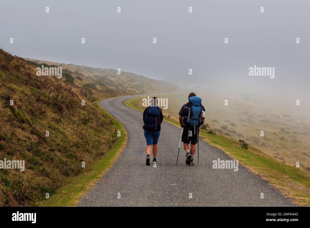 Couple of pilgrims walking along the Camino de Santiago through the ...