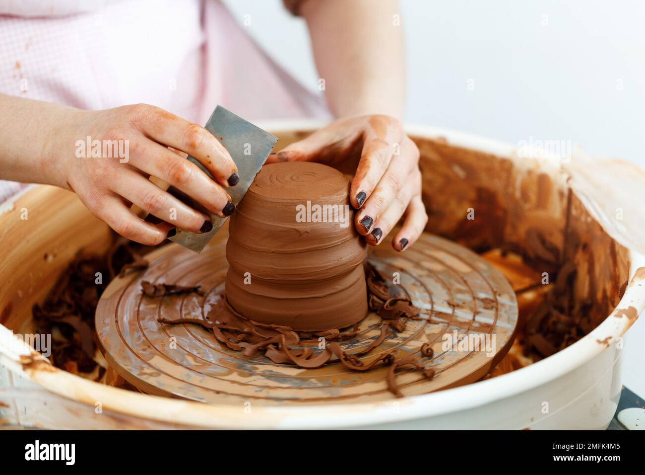 Master making a pot on pottery wheel, top view Stock Photo - Alamy