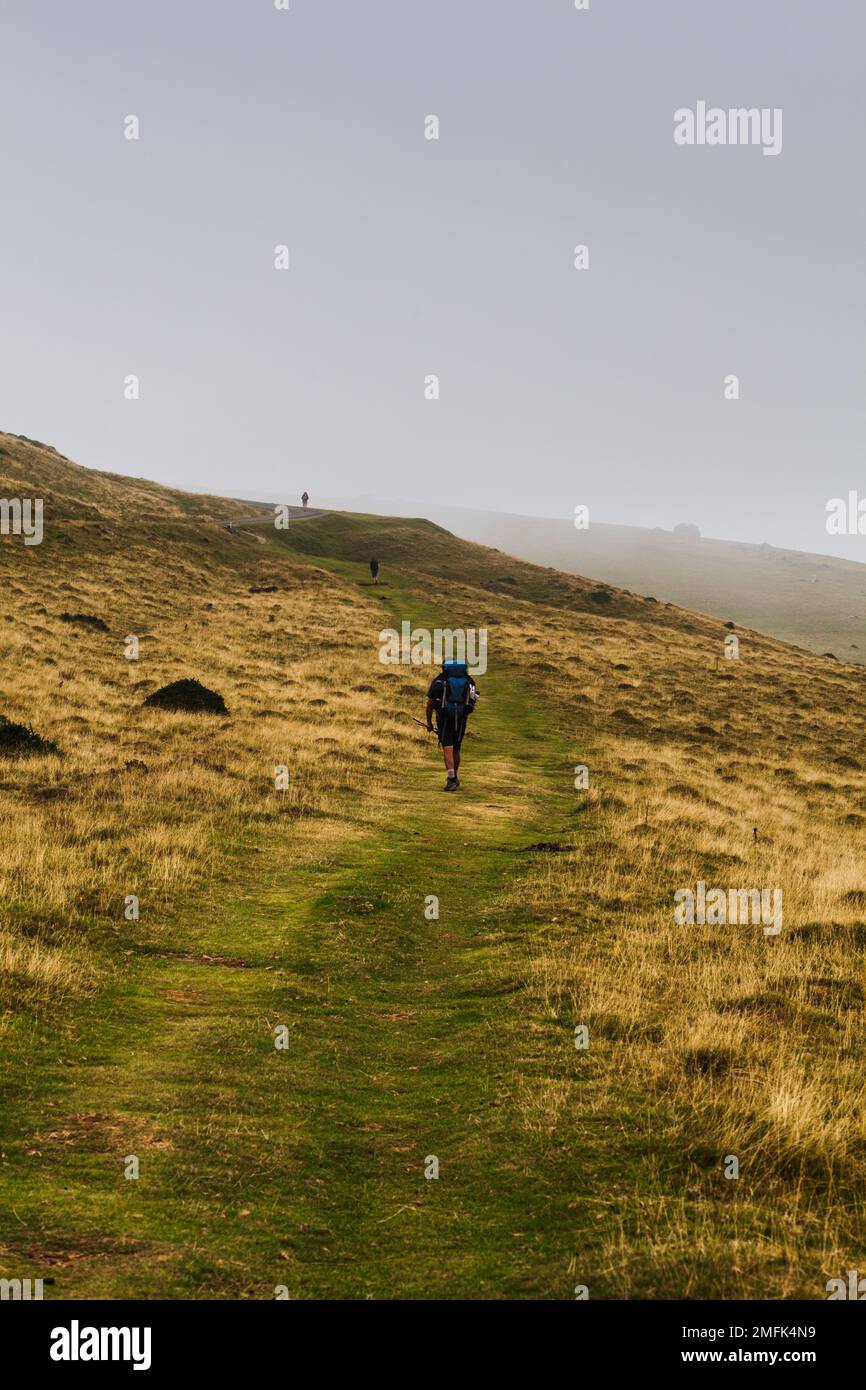 Pilgrim from behind along the Camino de Santiago. Path of the way of St ...