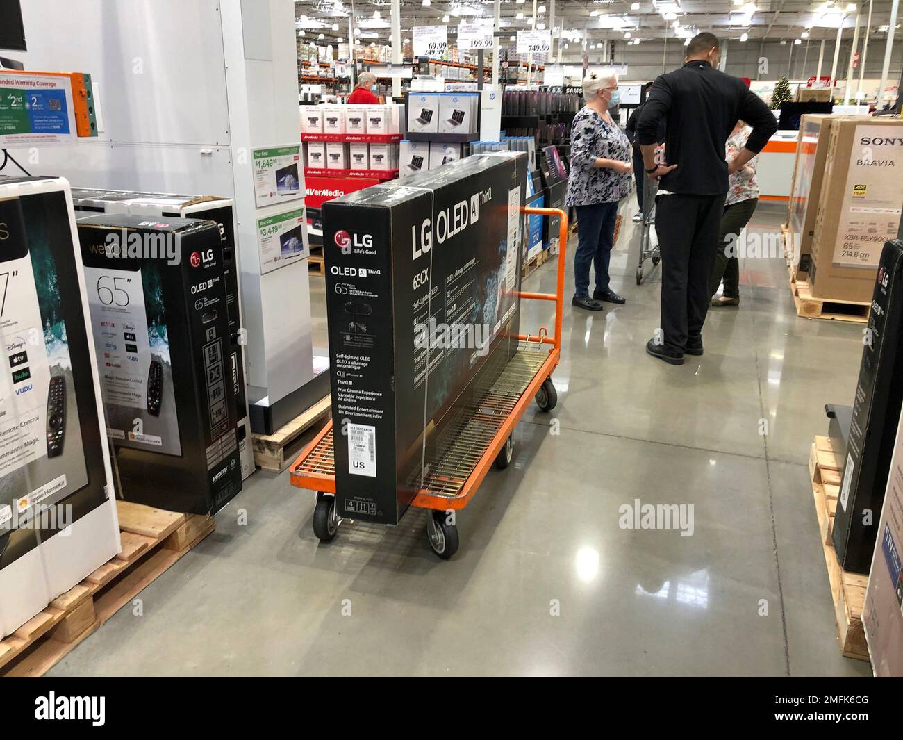 The shipping box containing a big-screen television is loaded on to a ...