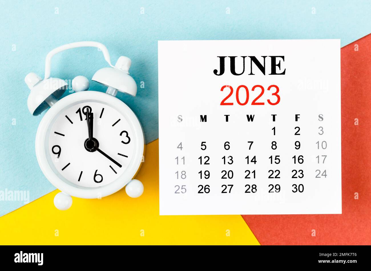 June 2023 Monthly calendar year with alarm clock on colourful ...