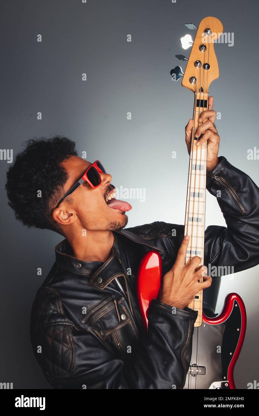 Handsome Black Musician Man With Leather Jacket Holding Bass. Portrait ...