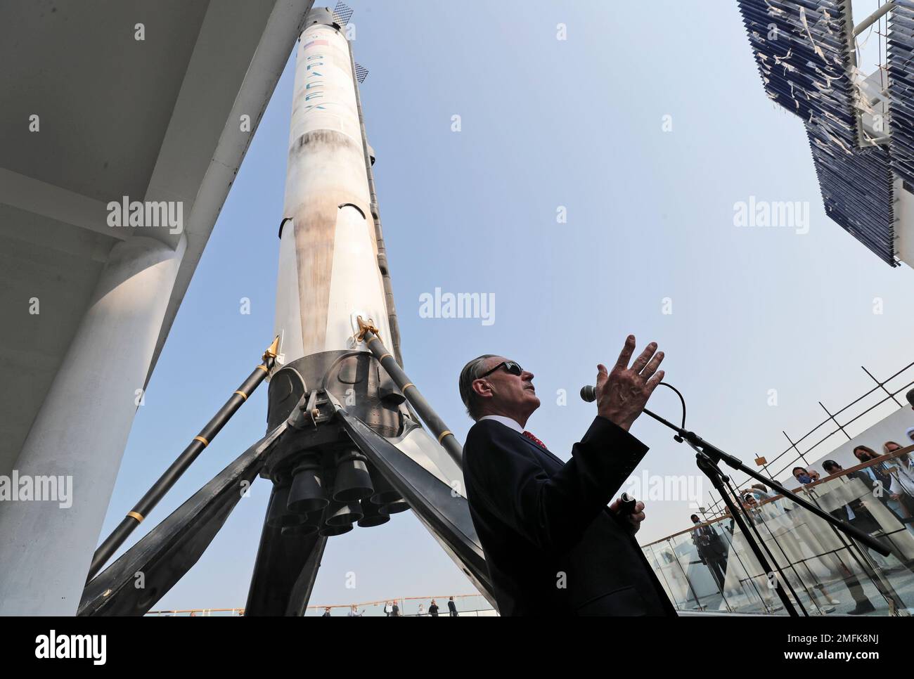 U.S. Ambassador John Rakolta talks in front of replica of the SpaceX ...