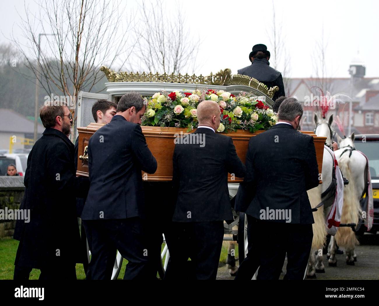 The bearer party, including father Tim Edwards (right), carry the ...