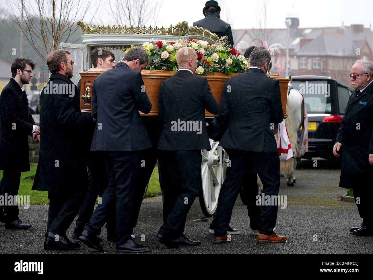 The bearer party, including father Tim Edwards (right), carry the ...