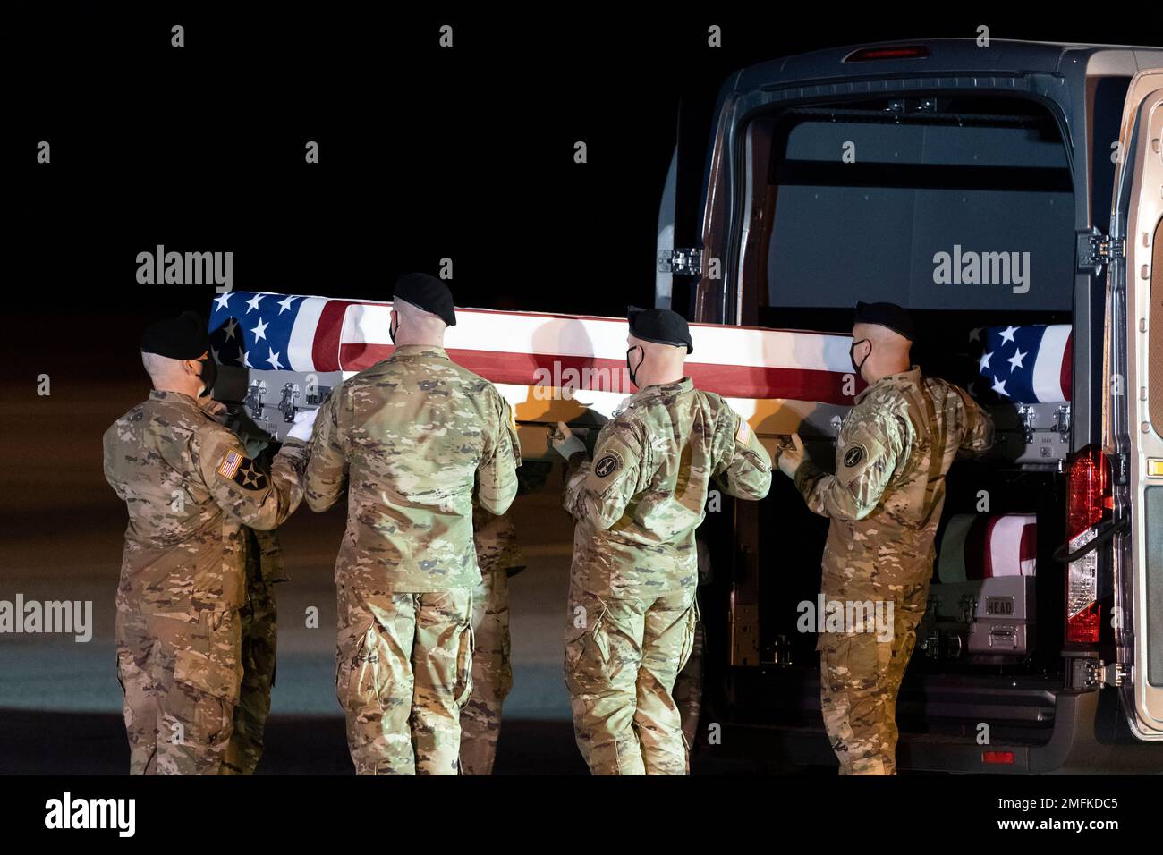 An Army carry team loads a transfer case containing the remains of U.S ...