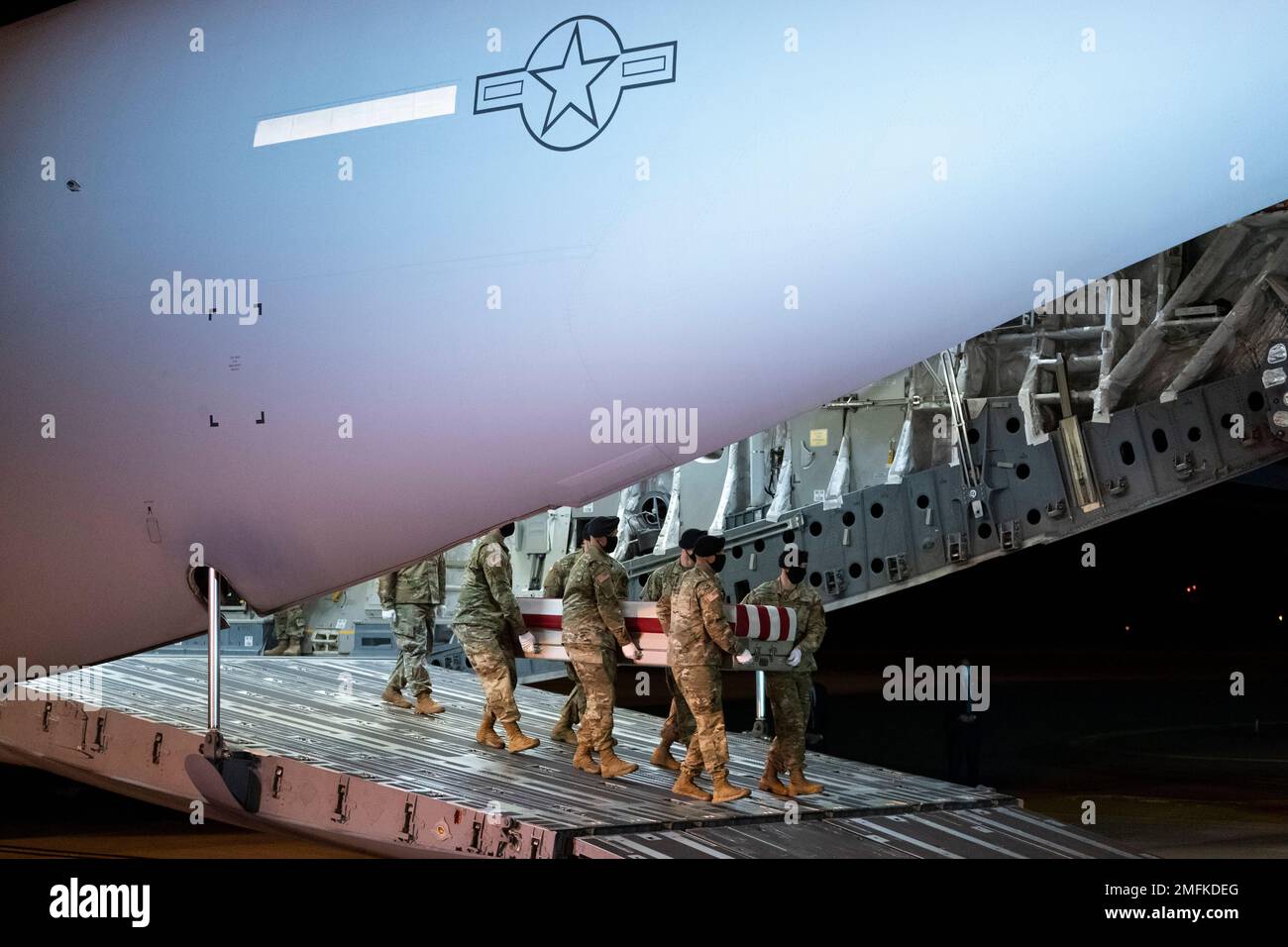 An Army carry team moves a transfer case containing the remains of U.S ...