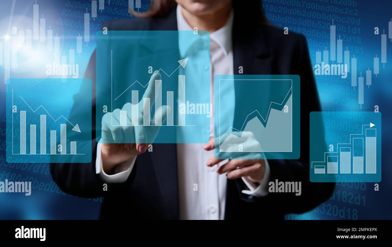 Business woman using digital virtual screen for data analytics plotting ...