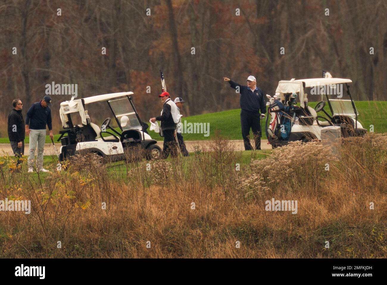 President Donald Trump, right, gestures as he plays golf at Trump ...