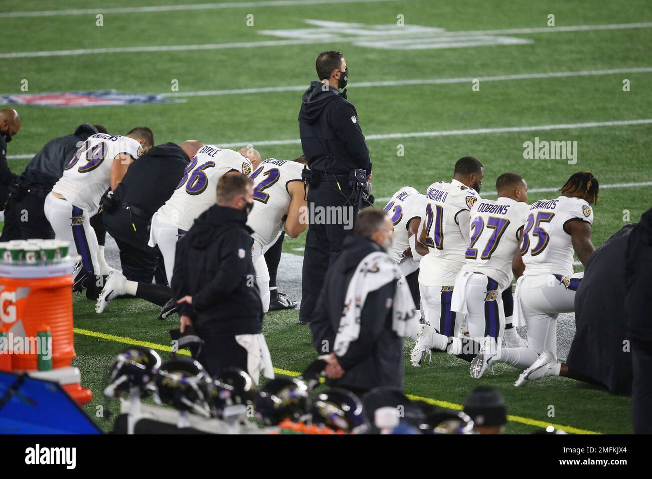 Some of the Baltimore Ravens kneel during the national anthem prior to ...