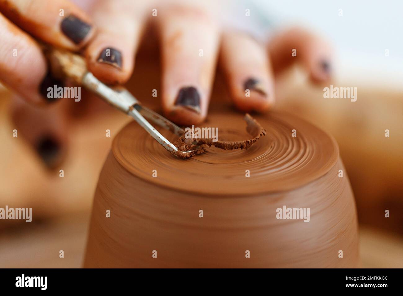 Female hands hold a bowl for casting clay products. Shaped method for ...