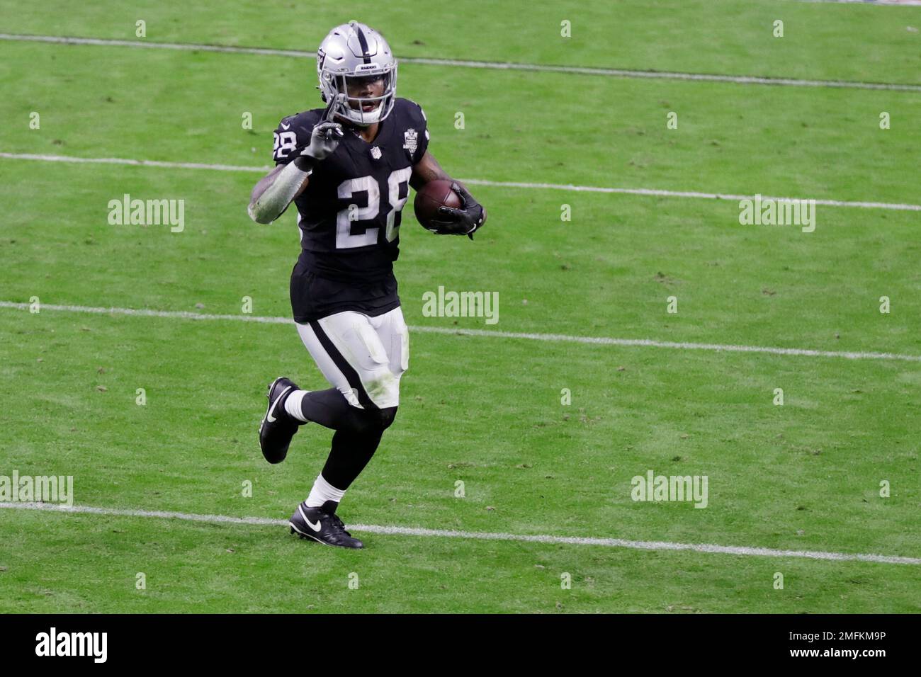 Las Vegas Raiders running back Josh Jacobs (28) reacts as he runs for a ...