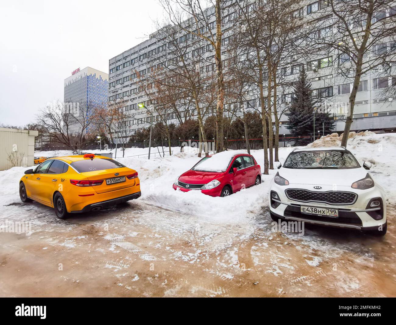 Moscow. Russia. January 23, 2023. A red Nissan Tiida car is frozen into ...