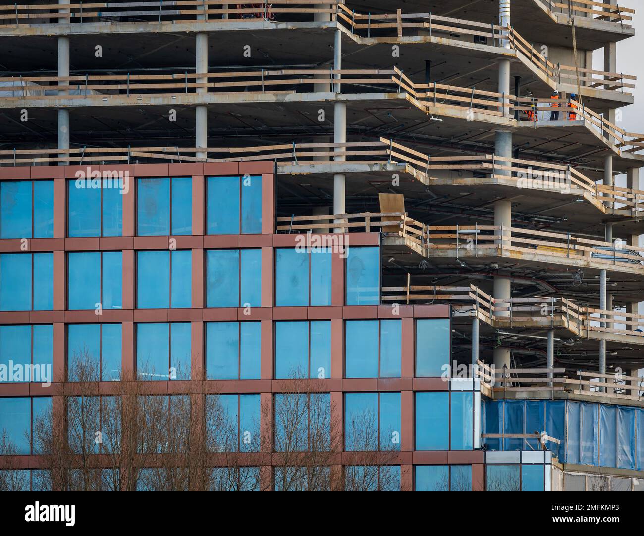 Modern high rise building under construction, partially finished facade ...