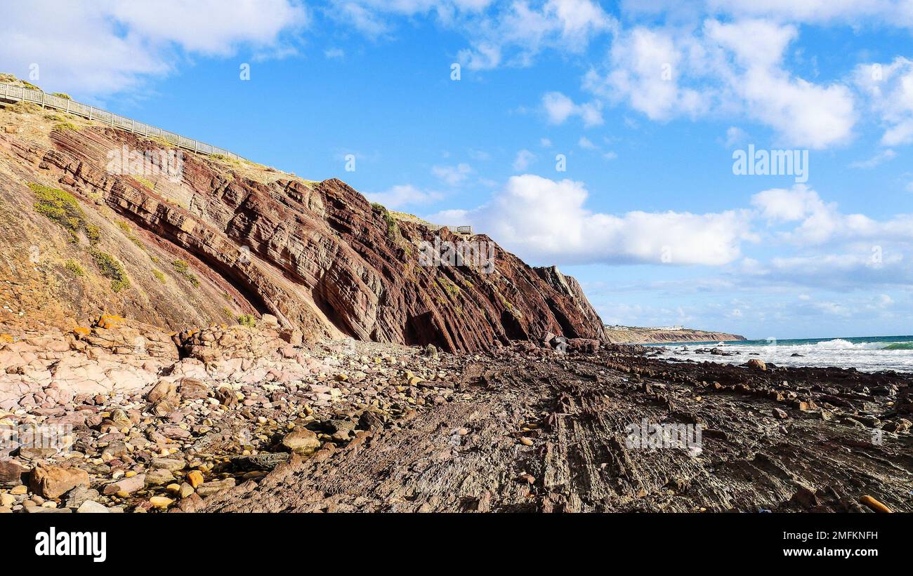 The beautiful rocky beach with rough cliffs and terrain at the sea on a ...