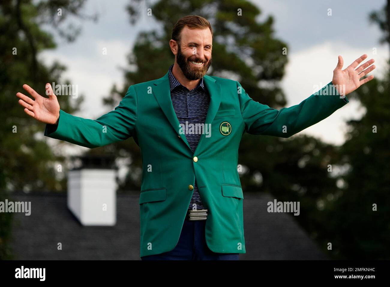 Masters golf champion Dustin Johnson shows off his green jacket after ...