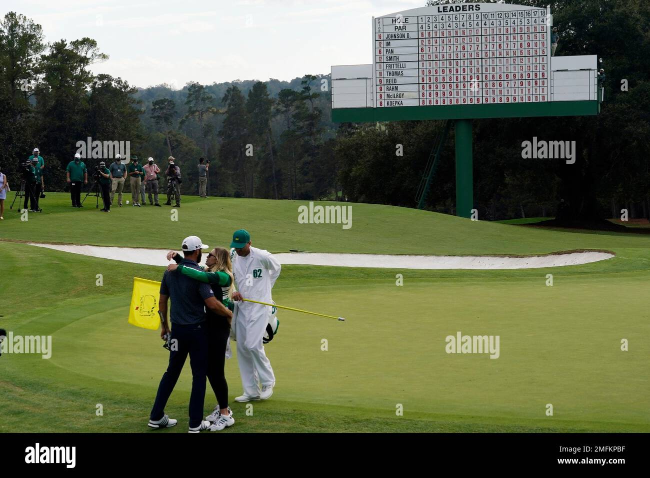 Dustin Johnson is hugged by Paulina Gretzky and his brother and caddie ...