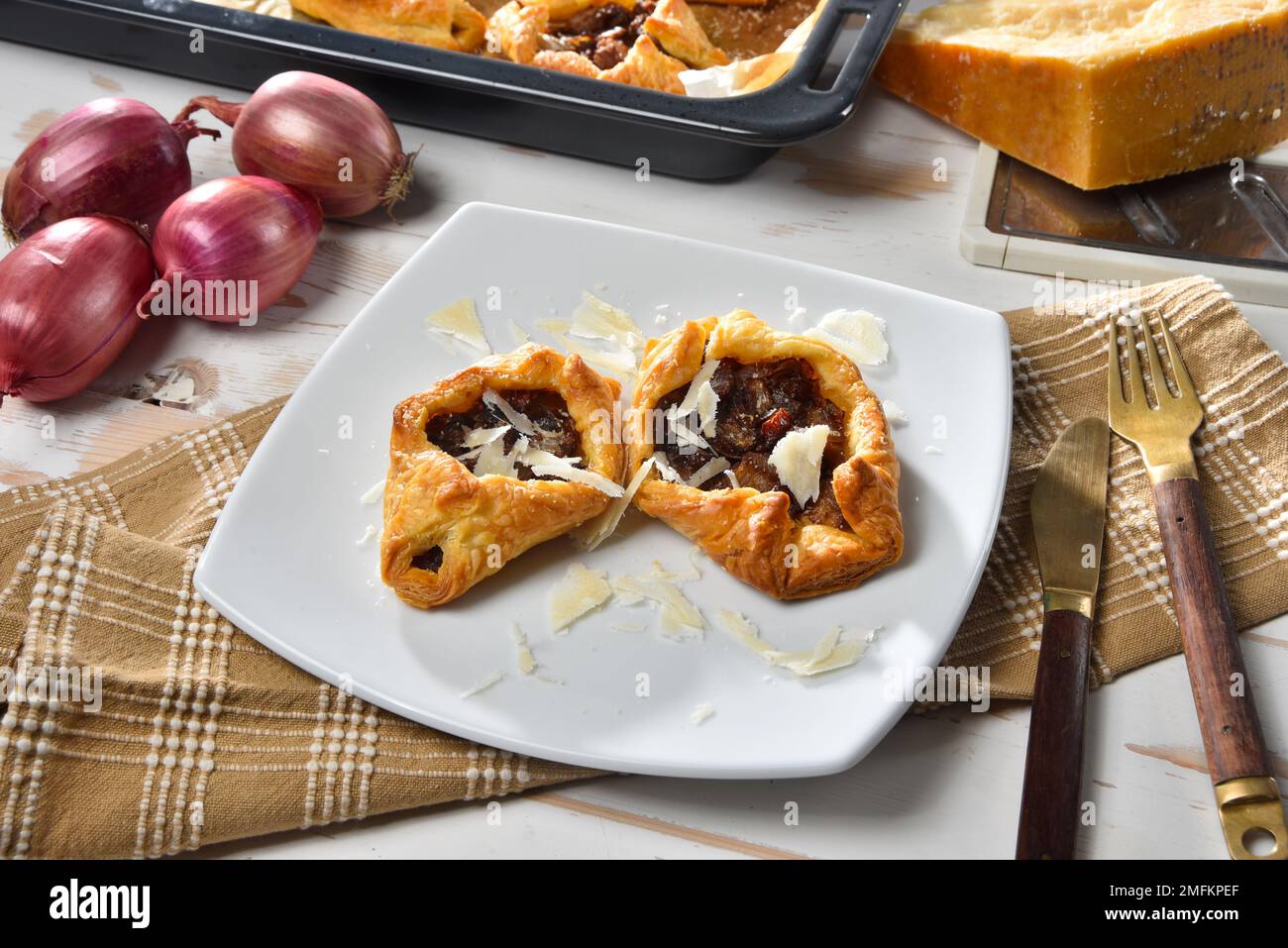 Puff pastry boats with red onions and Parmesan cheese Stock Photo - Alamy