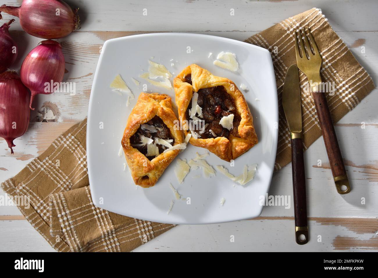 Puff pastry boats with red onions and Parmesan cheese Stock Photo - Alamy