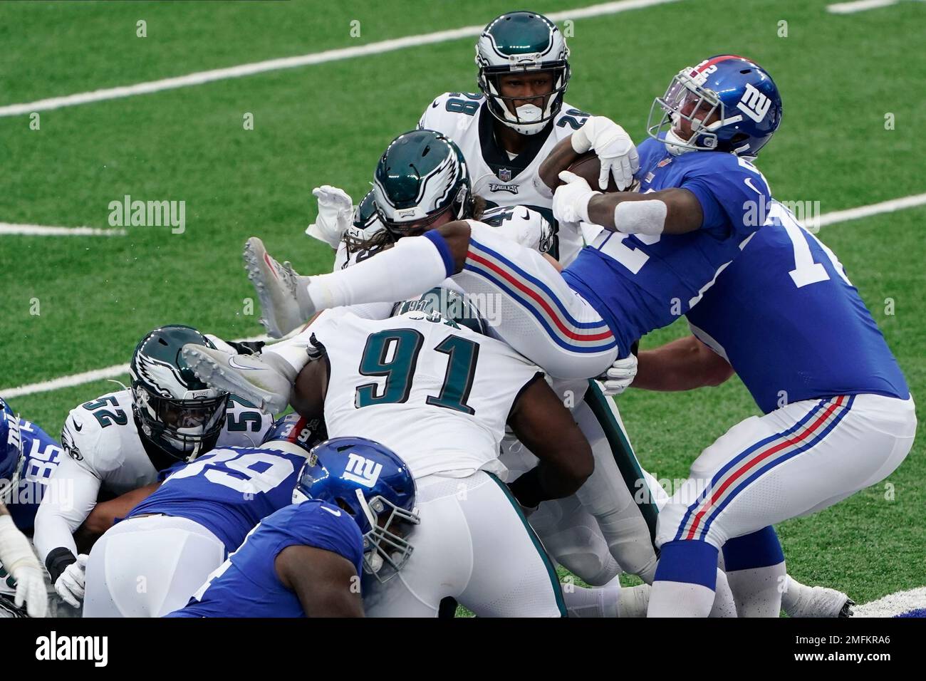 New York Giants running back Wayne Gallman (22) jumps over defenders ...
