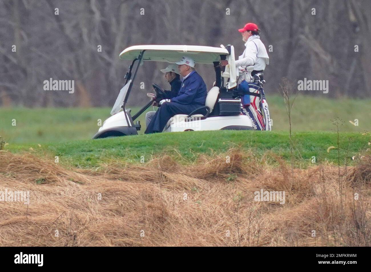 President Donald Trump drives a golf chart at Trump National Golf Club ...