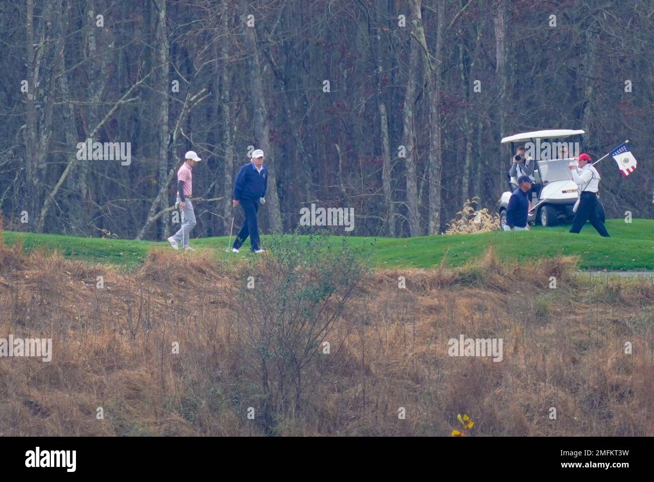 President Donald Trump, second from the left, plays golf at Trump ...