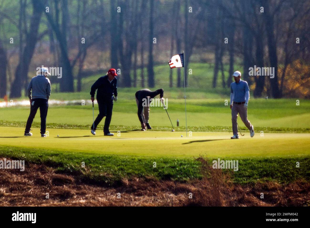 President Donald Trump, second from left, plays golf at Trump National ...