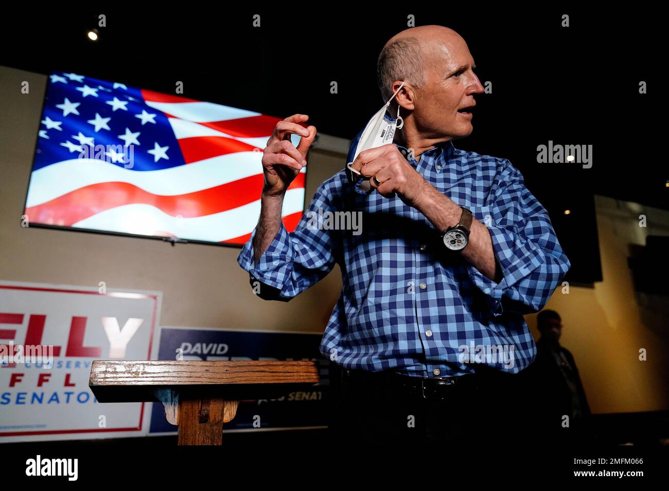 Sen. Rick Scott, R-Fla., takes off his mask before he speaks to the ...