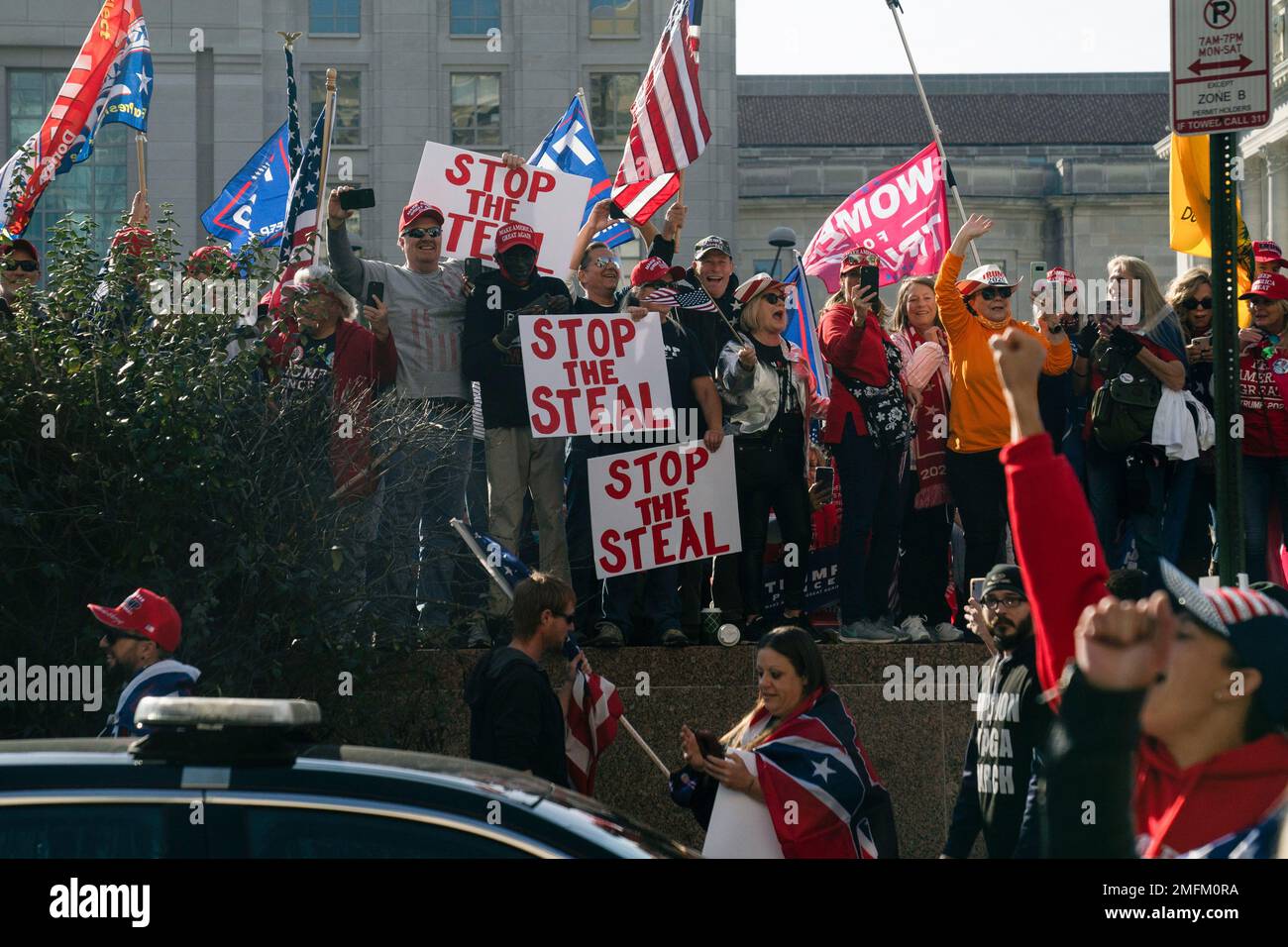 Supporters of President Donald Trump cheer as his motorcade drives past ...