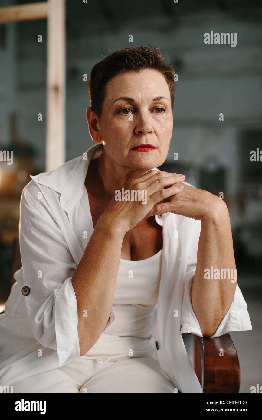 A mature woman poses in a film studio. Emotional portrait of the ...
