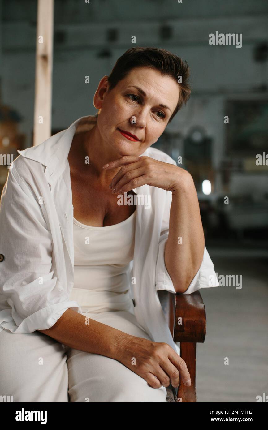 A mature woman poses in a film studio. Emotional portrait of the ...