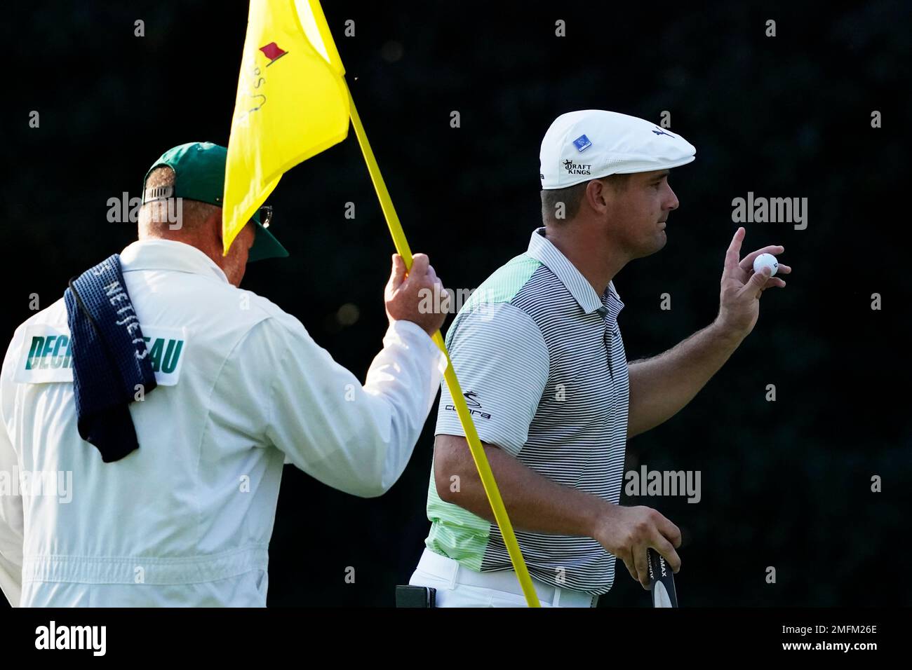 Bryson DeChambeau holds up his ball after a birdie on the sixth hole ...