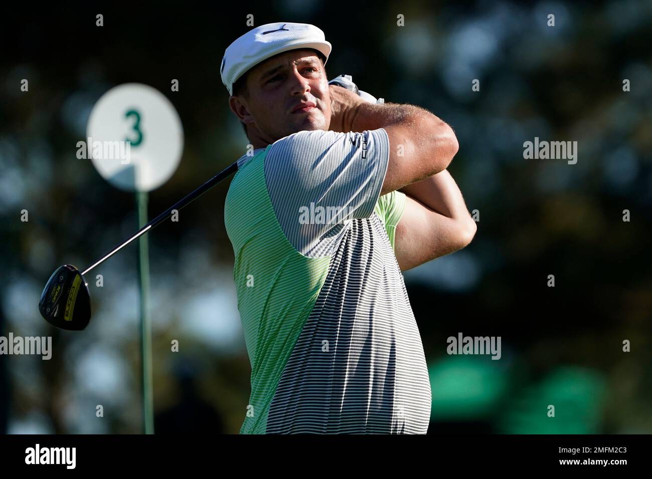 Bryson DeChambeau watches his second tee shot on the third hole after ...