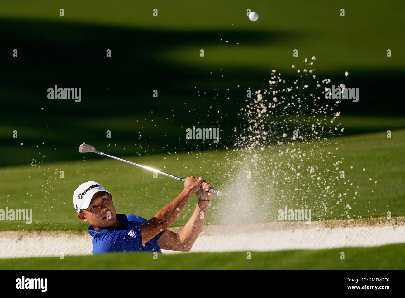 Collin Morikawa hits out of a bunker on the ninth hole during the ...
