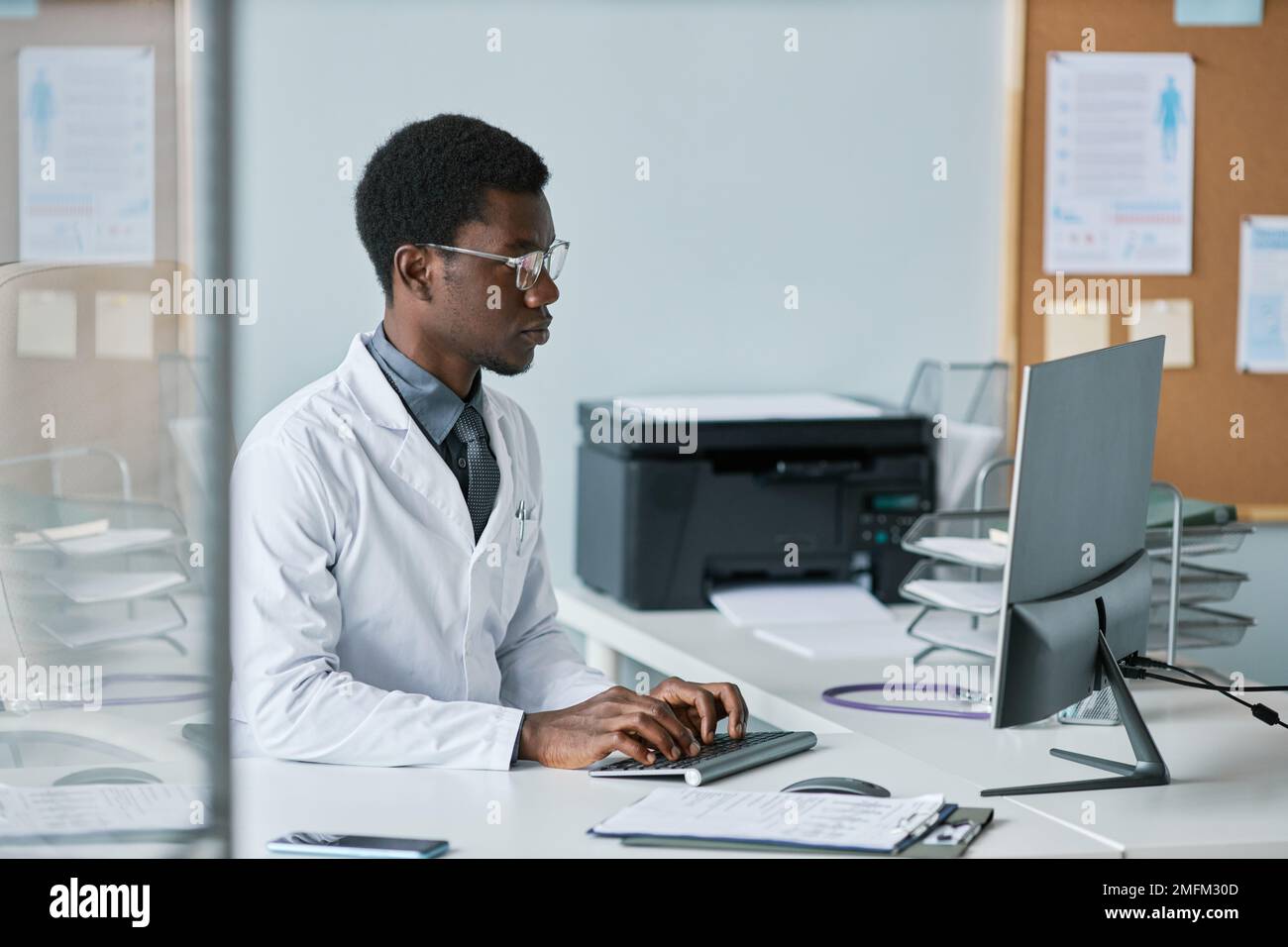 Doctor typing in office hi-res stock photography and images - Alamy