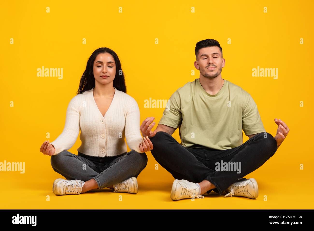 Cheerful relaxed young arabic woman and guy in casual with closed eyes ...