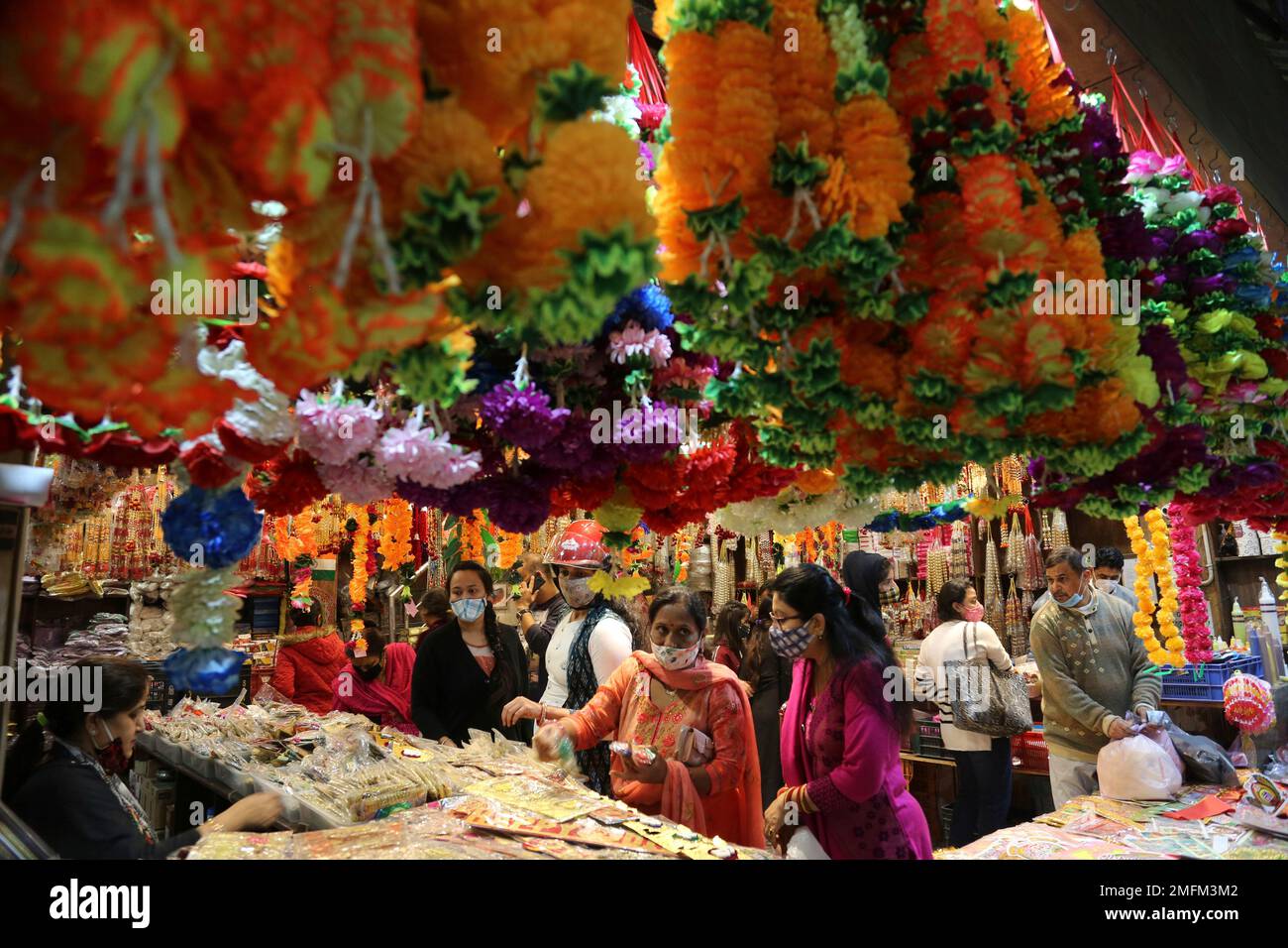 Indians shop on the eve of the Hindu festival of lights Diwali, in ...